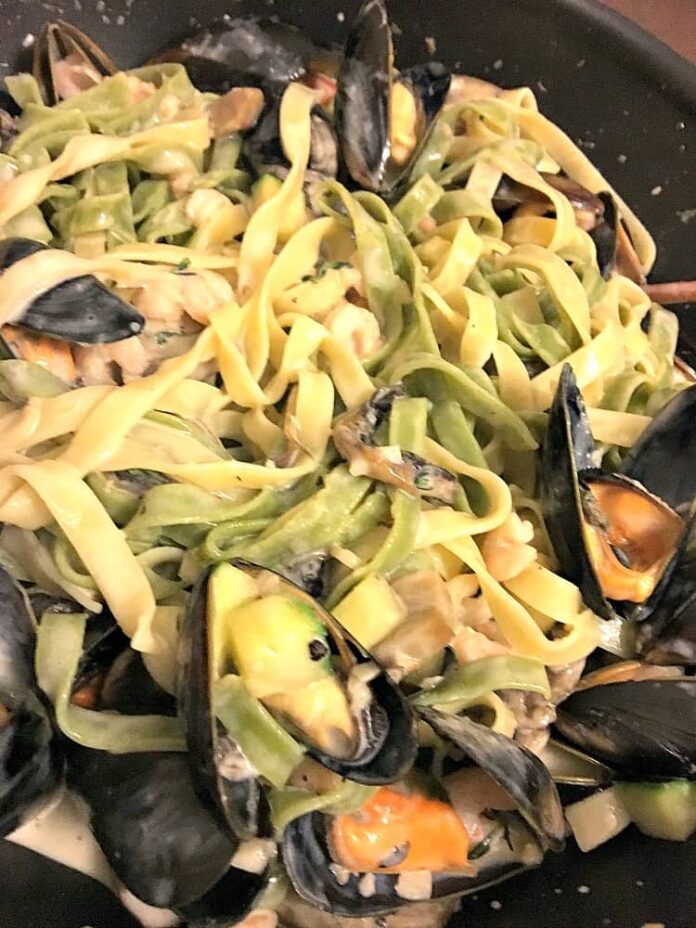 Creamy Garlic Seafood Pasta, with a delicious creamy white wine sauce.